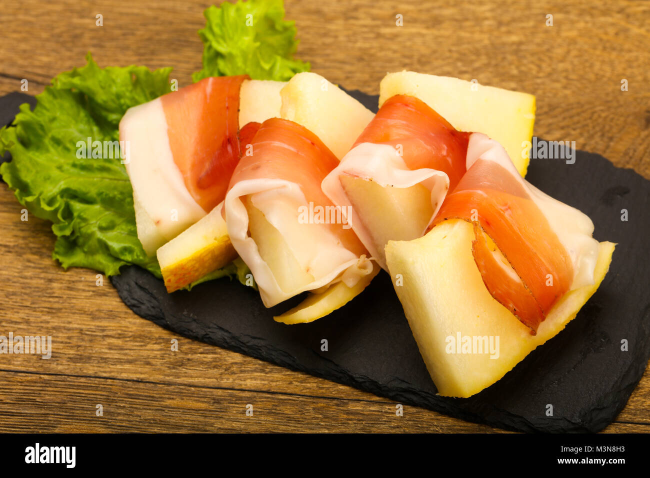 Spanish Hamon with melon Stock Photo - Alamy