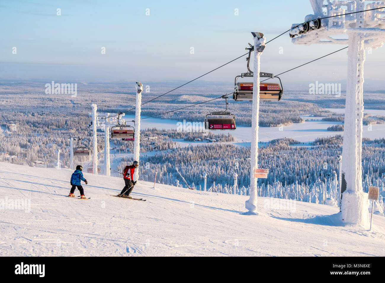 Skiers on the piste at The ski resort of Ruka in Finland Stock Photo ...