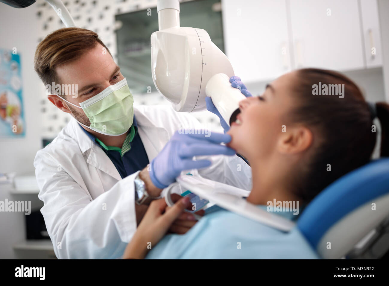Dental doctor looking patient teeth with apparatus Stock Photo - Alamy
