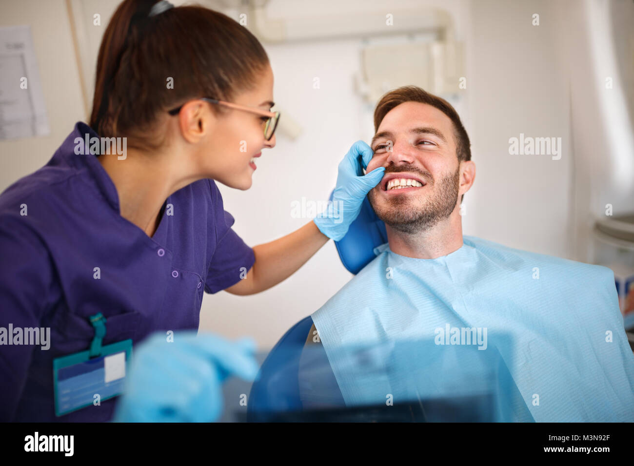 Dentist looking patient’s teeth in ordination Stock Photo - Alamy