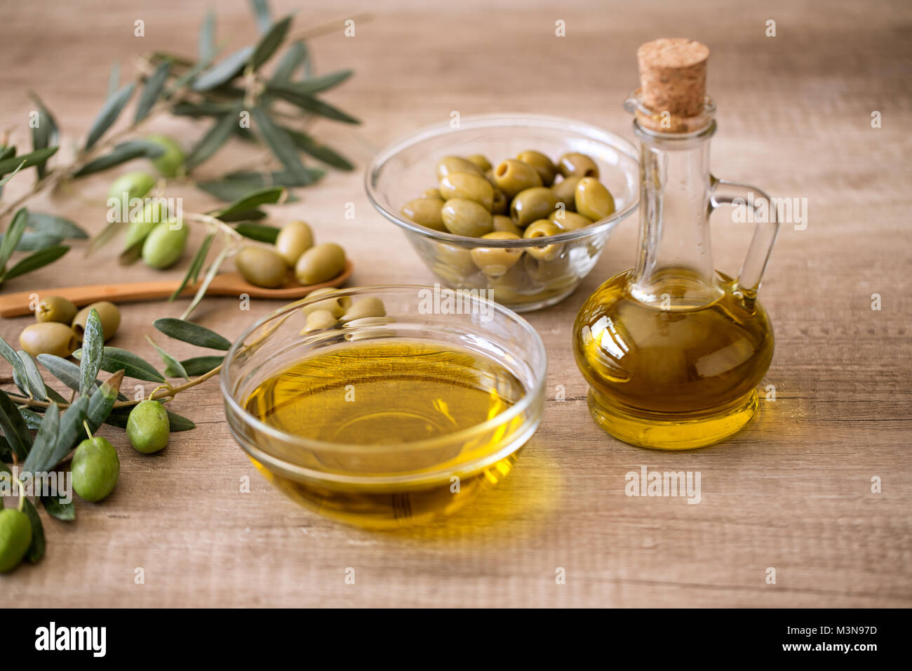 Extra virgin healthy Olive oil with fresh olive on wooden background ...