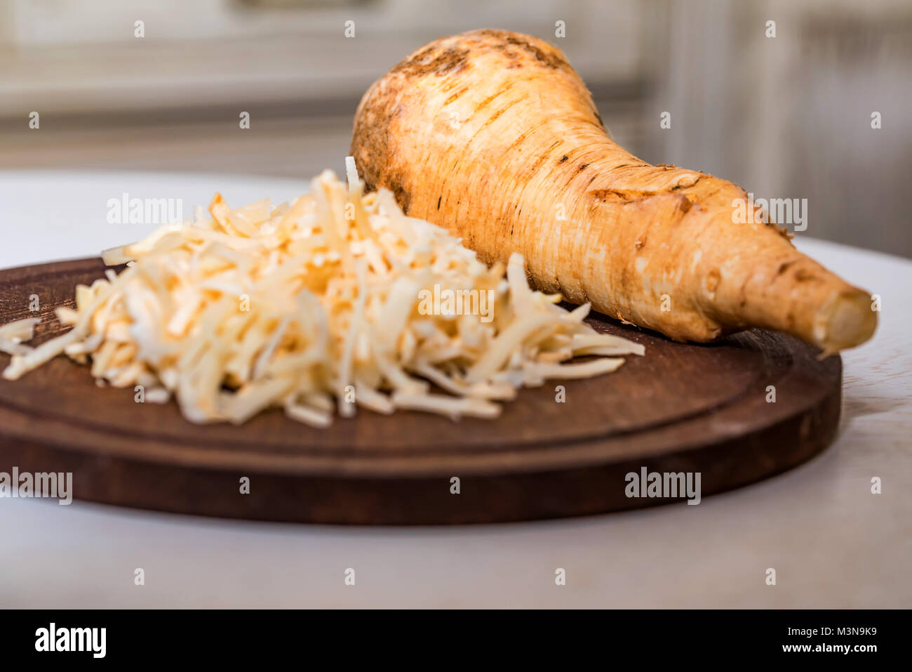Chopped parsnip on wooden board close Stock Photo - Alamy