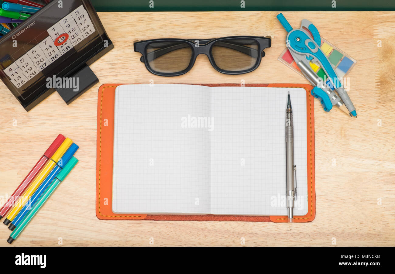 Top view of open notebook with Compasses, eyeglasses,calendar on wooden ...