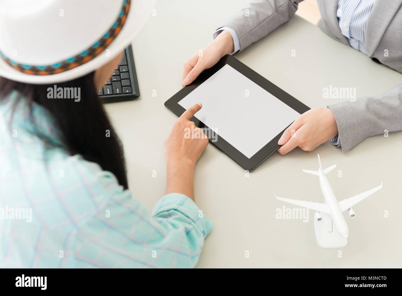 high angle view photo of travel agent company employee using mobile pad ...
