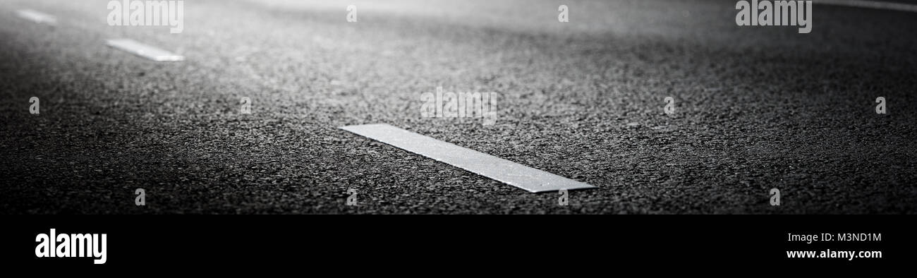 Asphalt road and dividing lines Stock Photo - Alamy