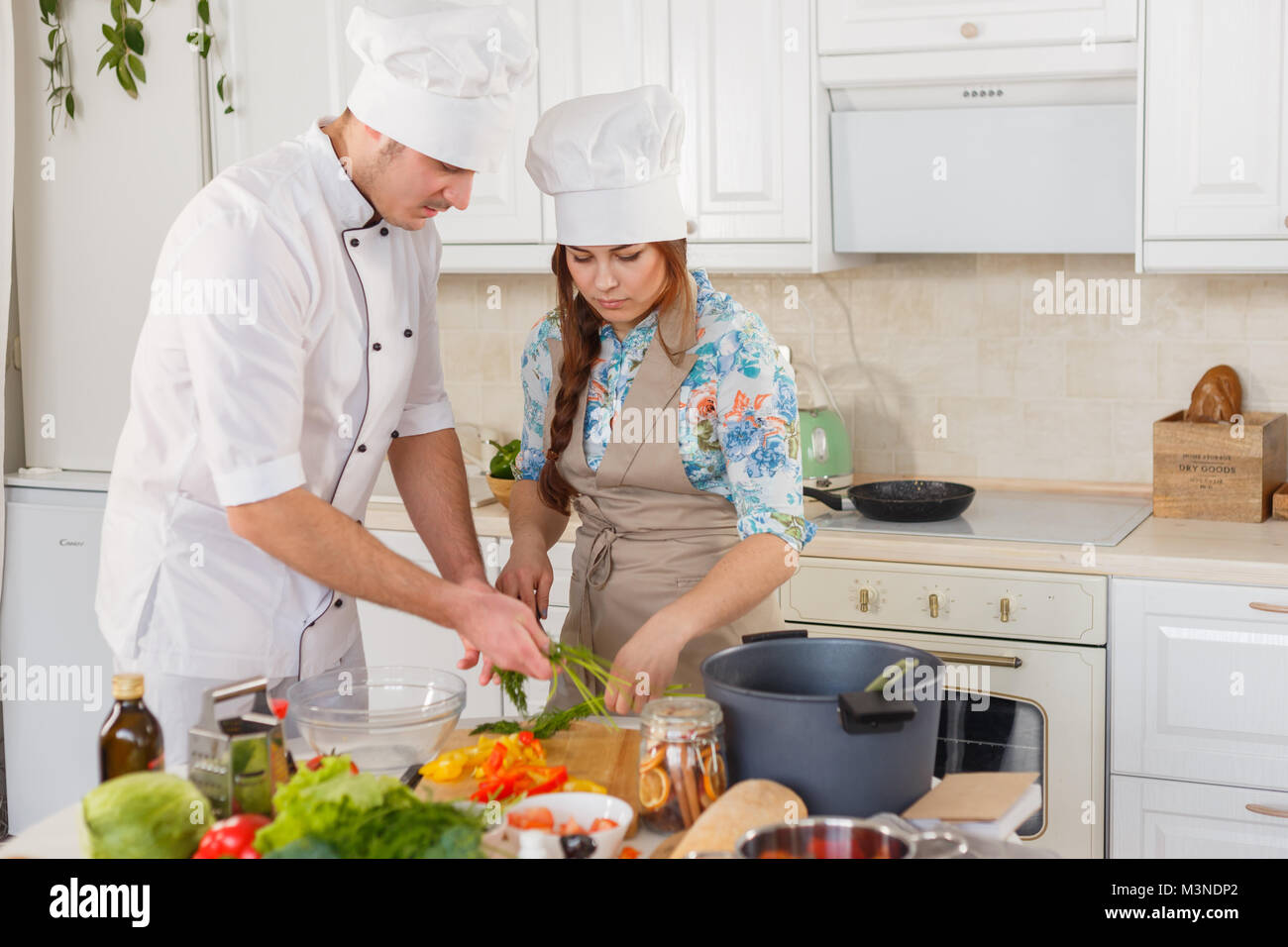 A senior chef giving cooking lesson to young chefs Stock Photo - Alamy