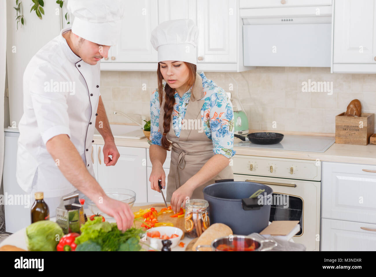 A senior chef giving cooking lesson to young chefs Stock Photo - Alamy