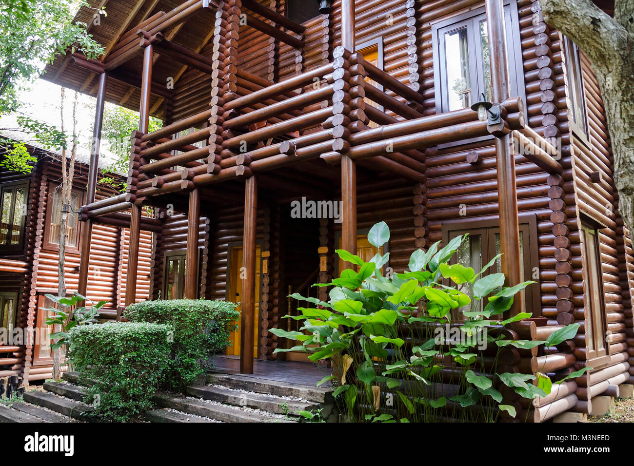 Log house - Cozy log house amongst green environment Stock Photo - Alamy