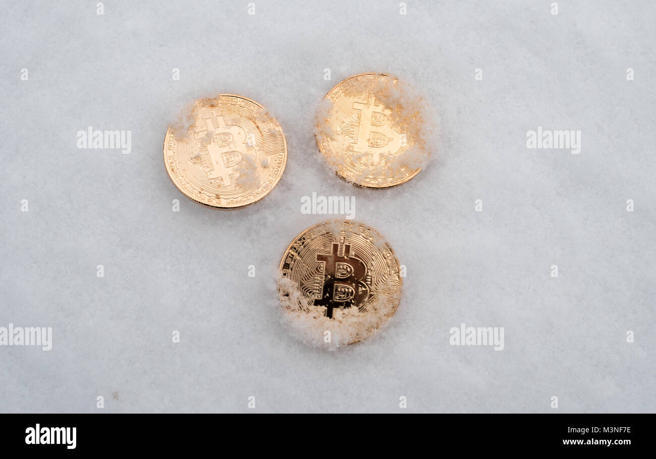 Gold coins bitcoin lie on white snow in winter. Crypto currency is the ...