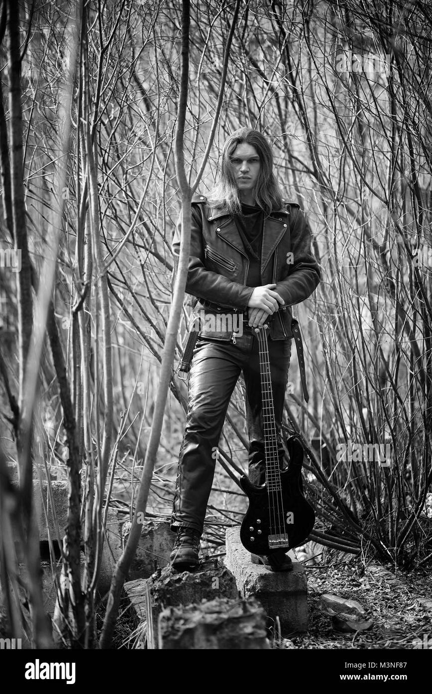 Rock guitarist outdoor. A musician with a bass guitar in a leath Stock ...