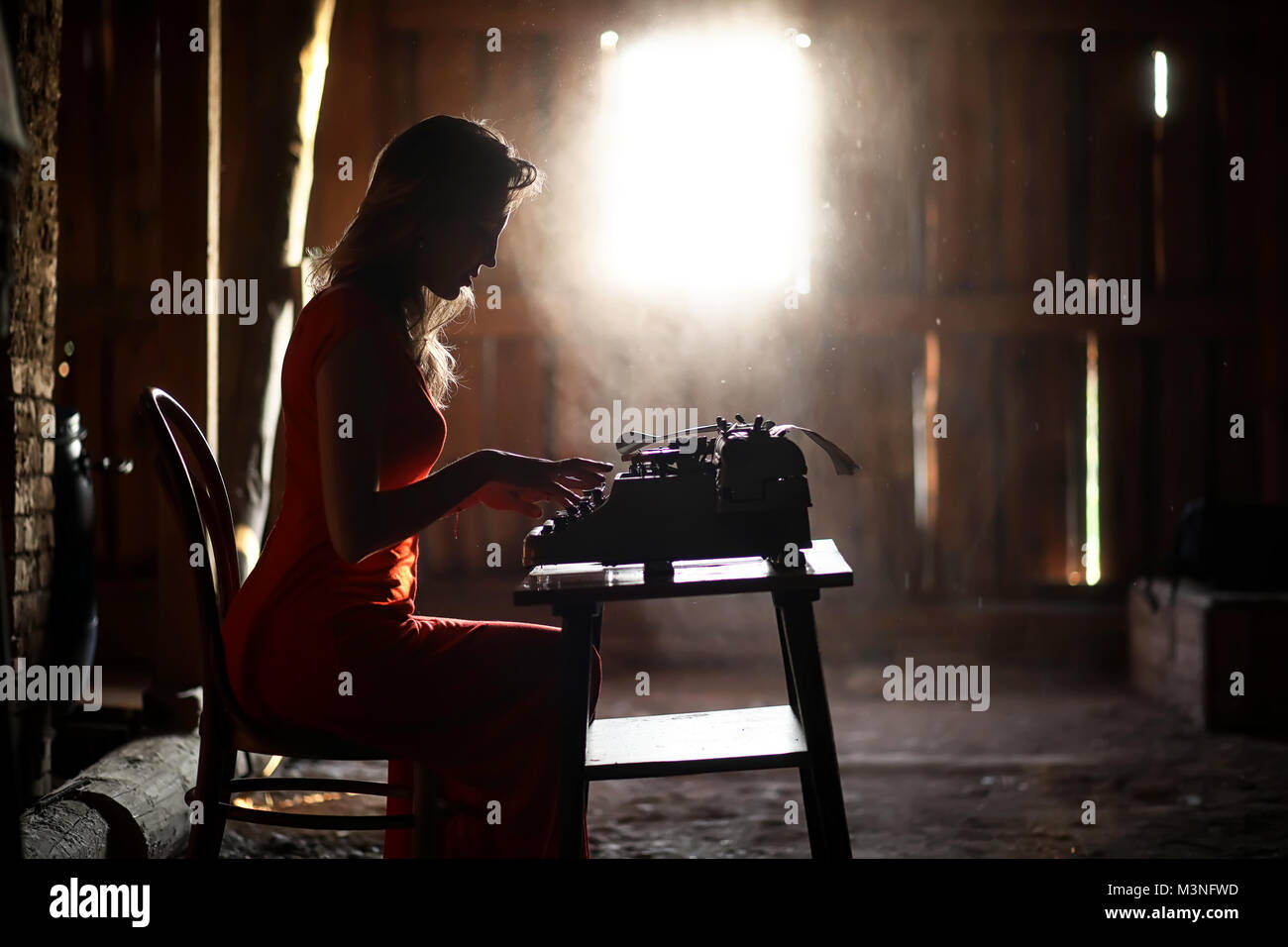 A girl in retro style prints on an old typewriter Stock Photo - Alamy