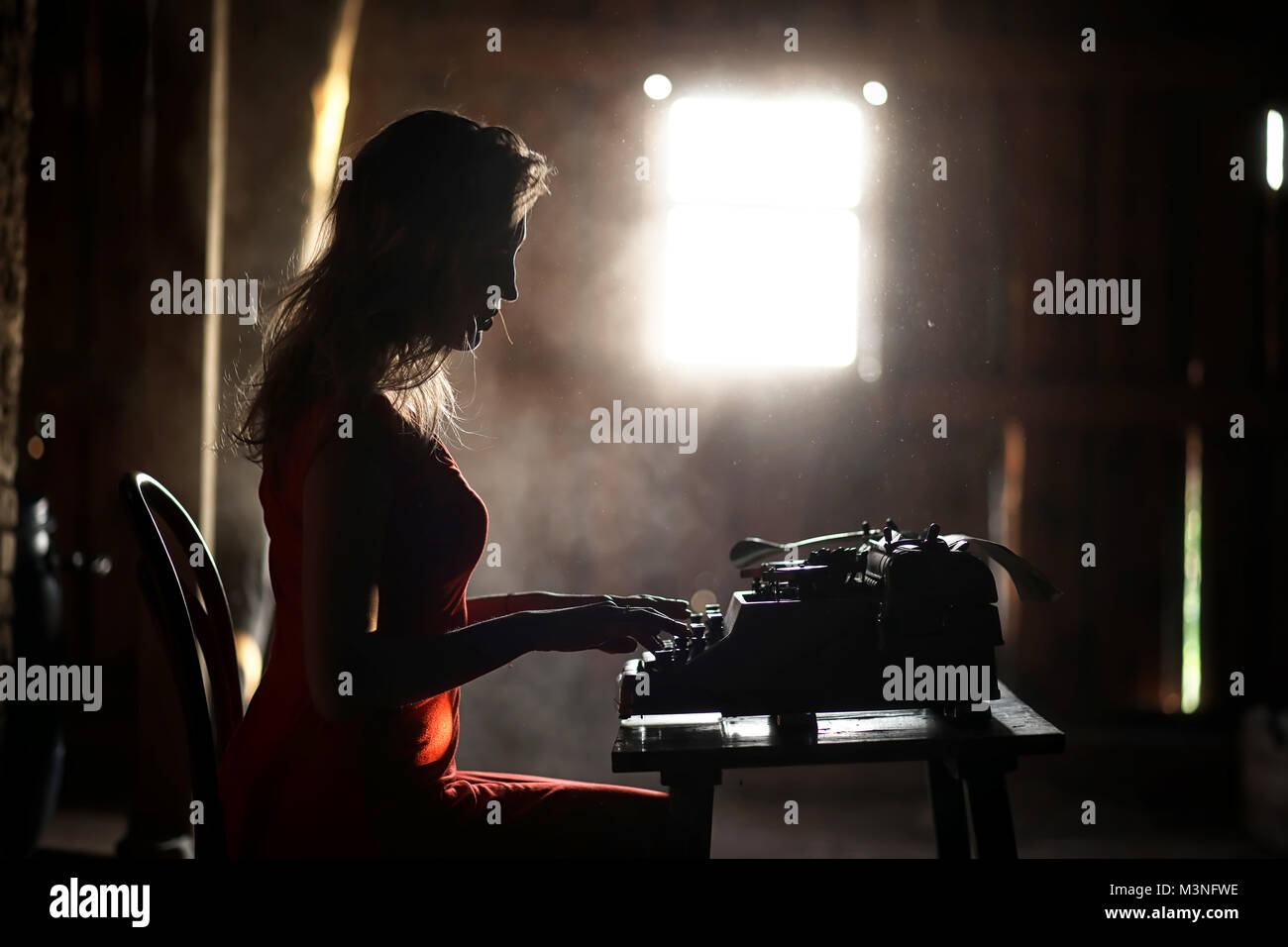 A girl in retro style prints on an old typewriter Stock Photo - Alamy