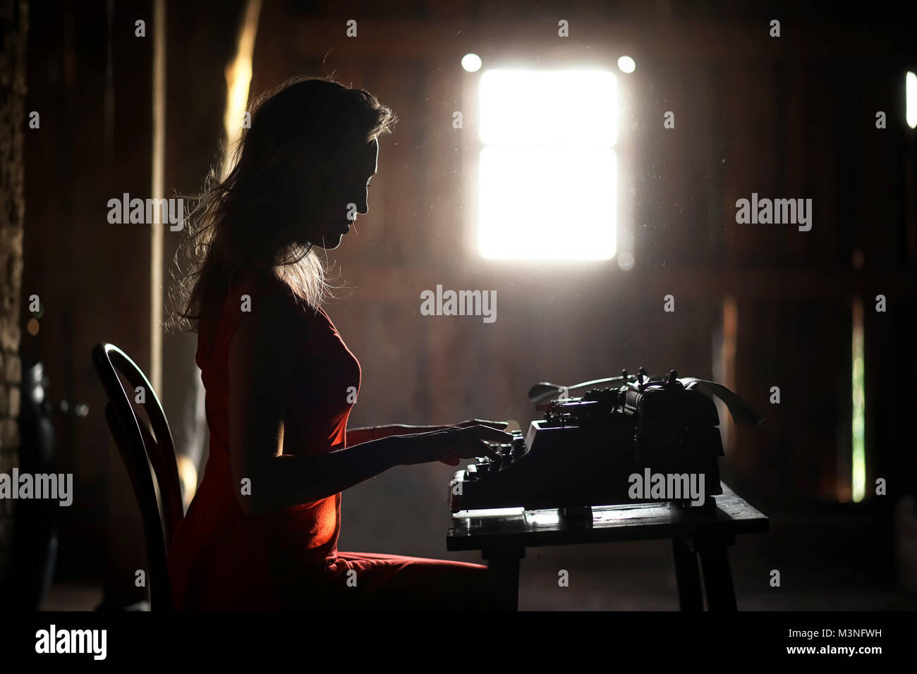 A girl in retro style prints on an old typewriter Stock Photo - Alamy