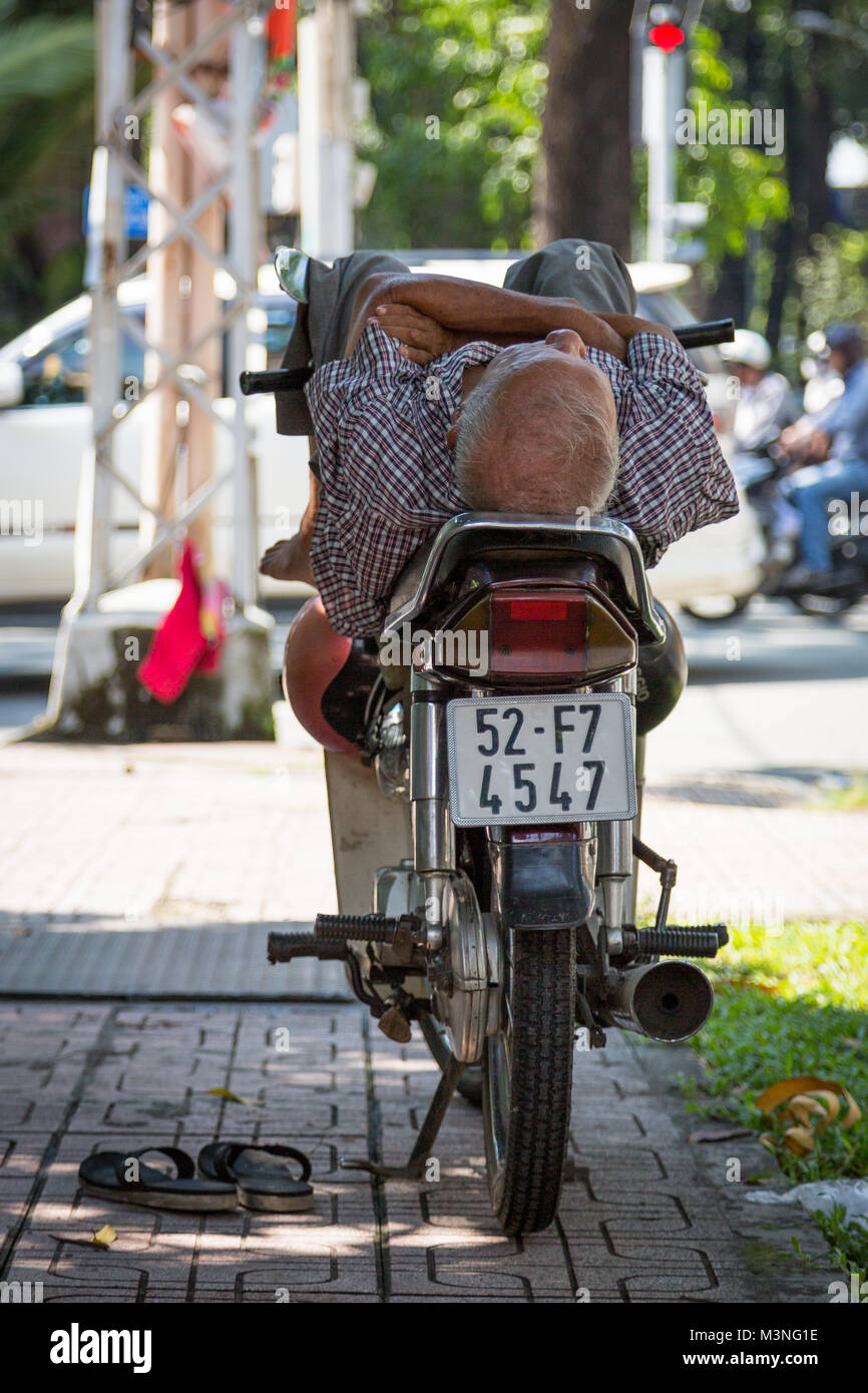 man sleeping on bike Stock Photo - Alamy