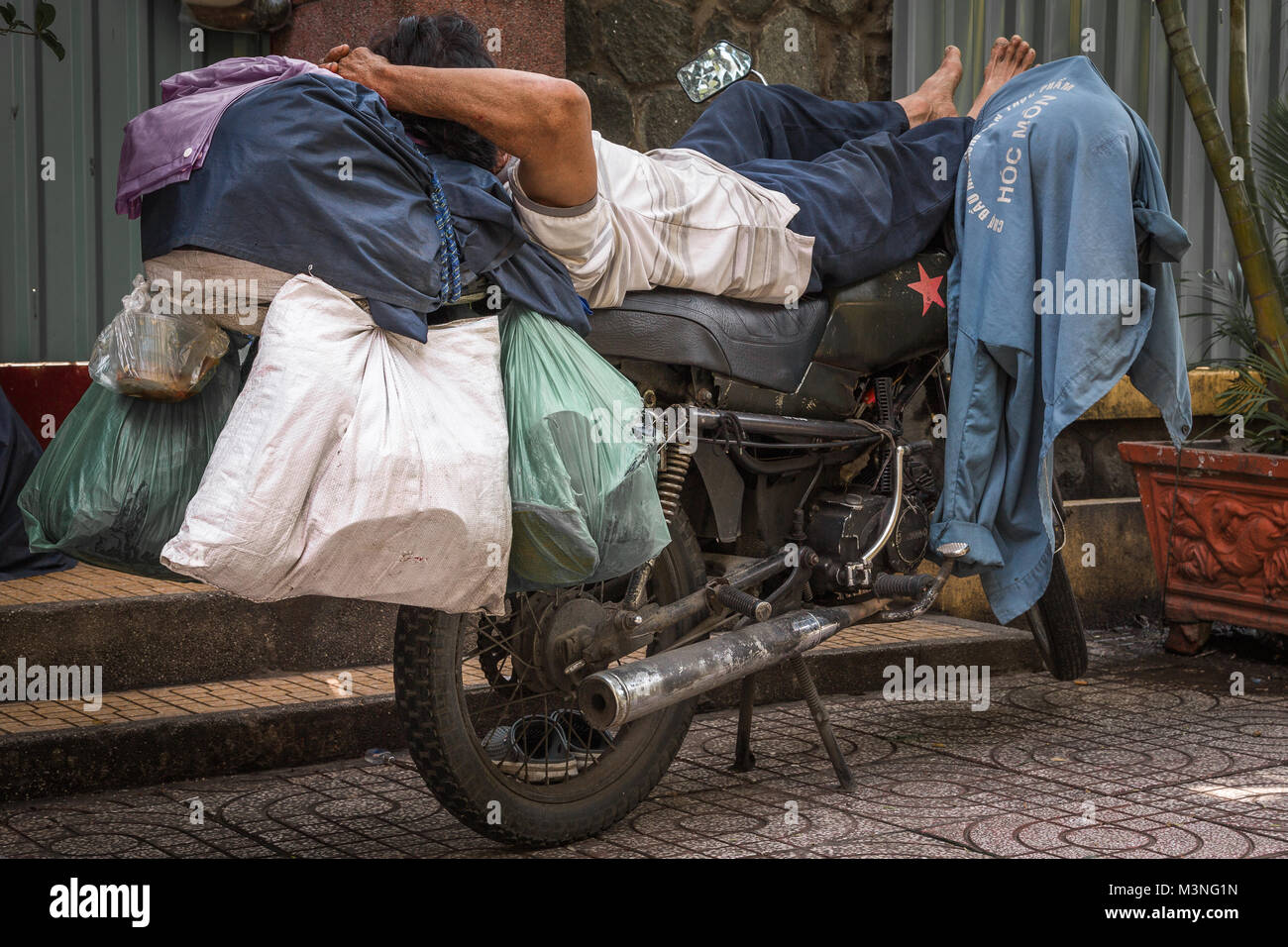 man sleeping on bike Stock Photo - Alamy
