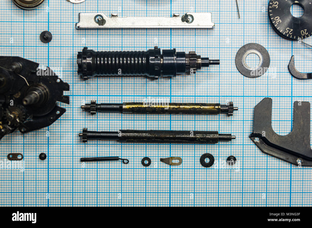 parts are completely disassembled old retro film SLR camera on graph ...