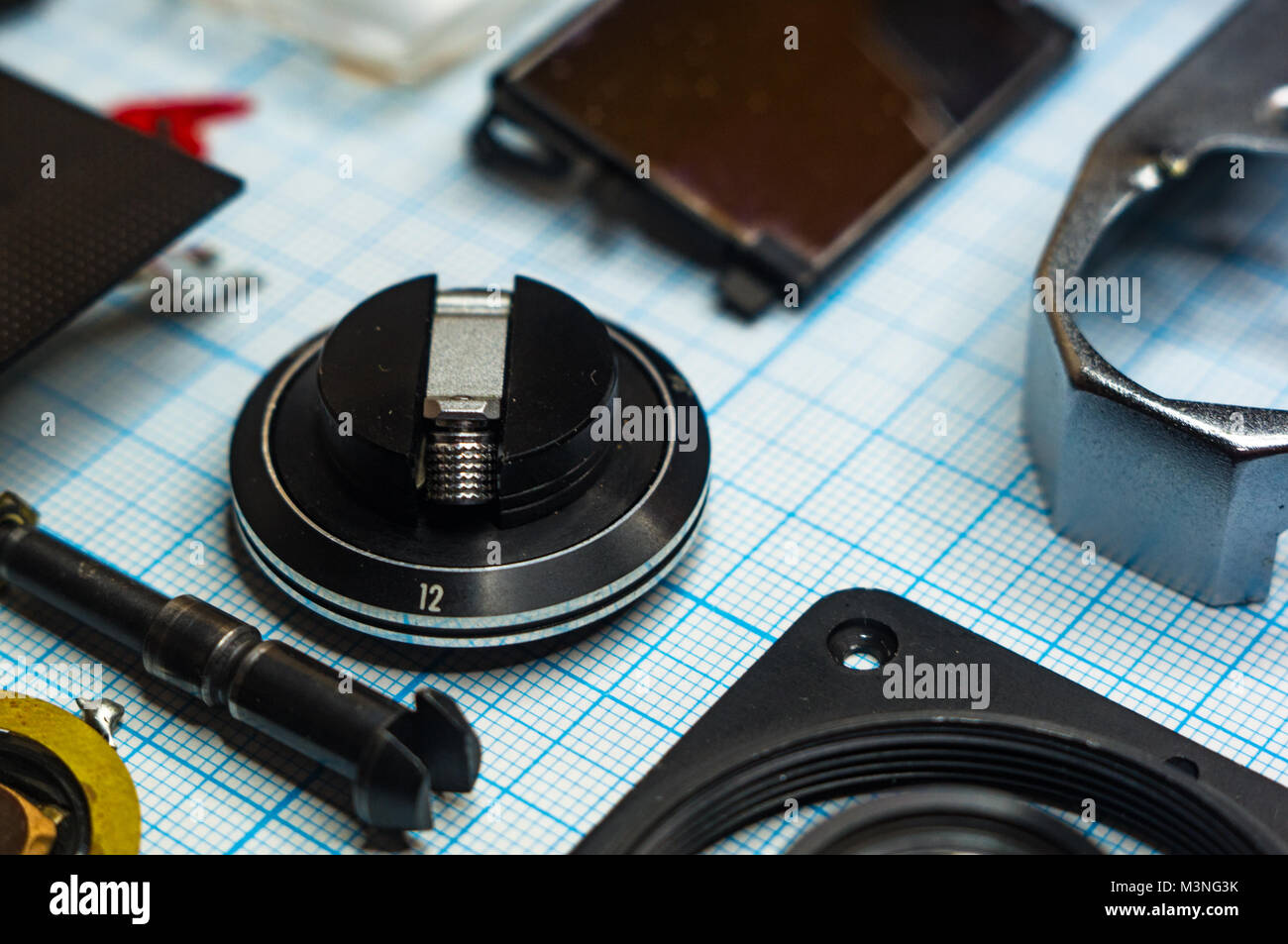parts are completely disassembled old retro film SLR camera on graph ...