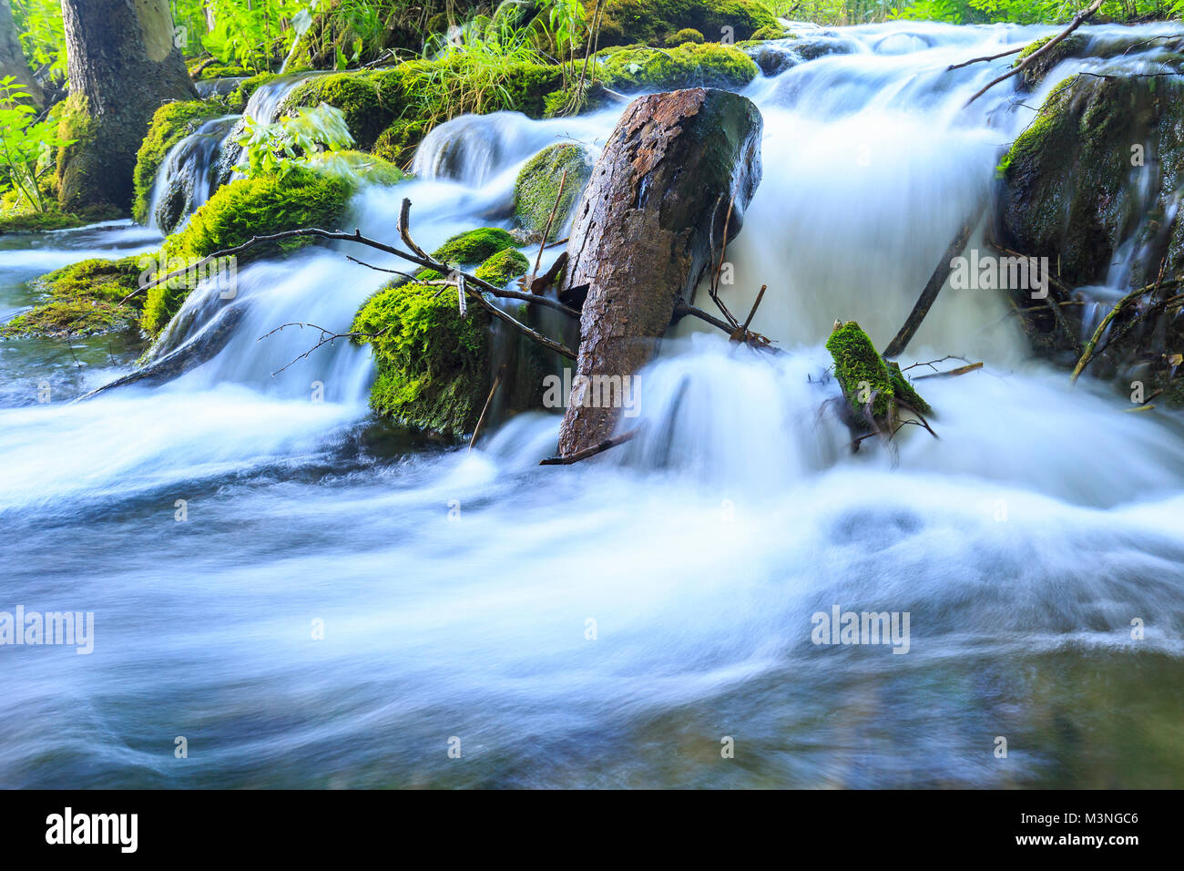 Close up of blue waterfalls in a green forest during daytime in Summer.Plitvice lakes, Croatia ...