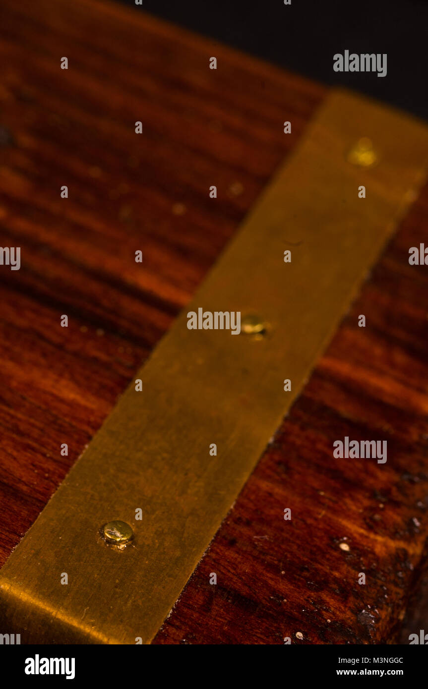 dark weathered teak wood with copper details, close up Stock Photo - Alamy