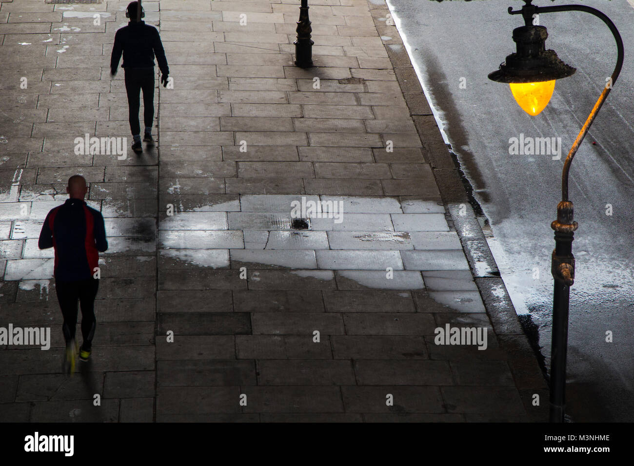 Walking under a bridge in London with a streetlight glow Stock Photo ...