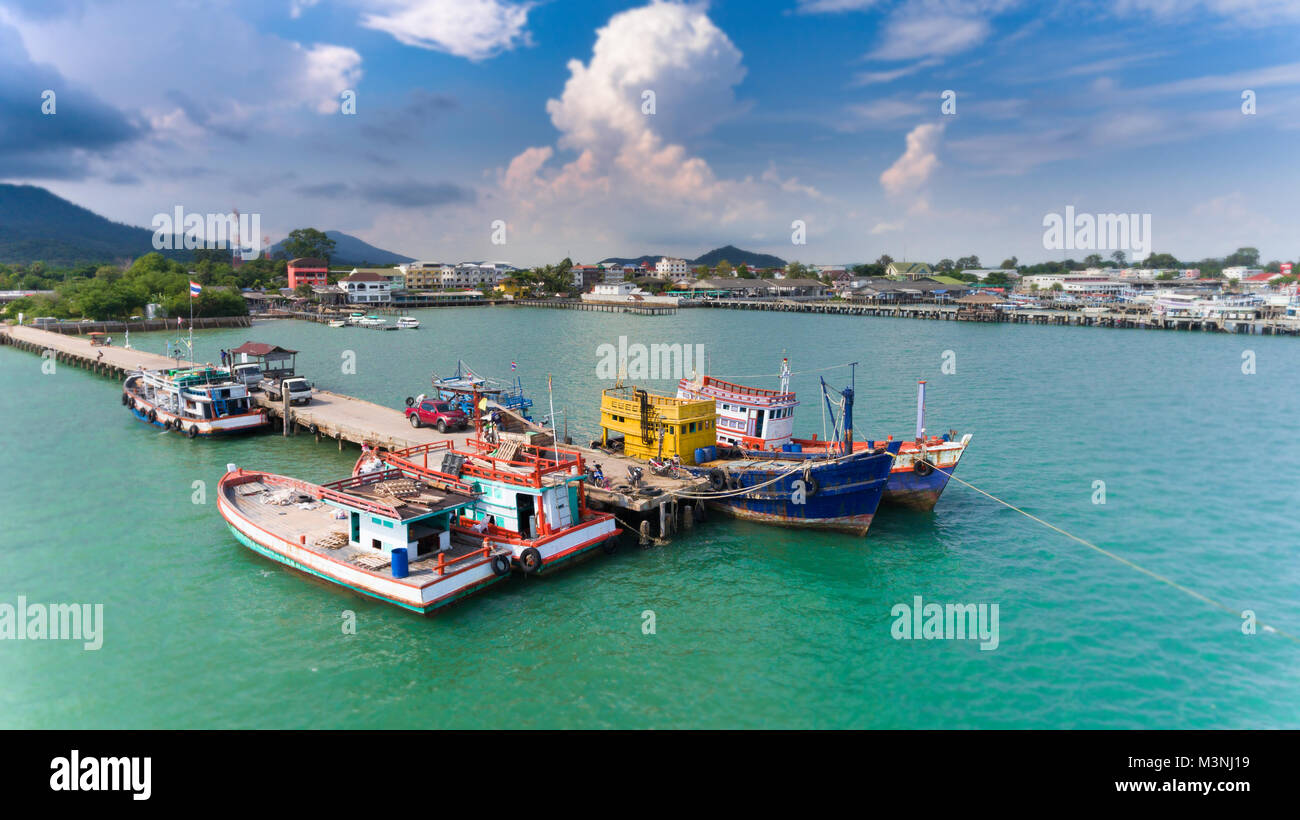 Wooden fishing boats floating at the harbor photo in outdoor sunlight ...