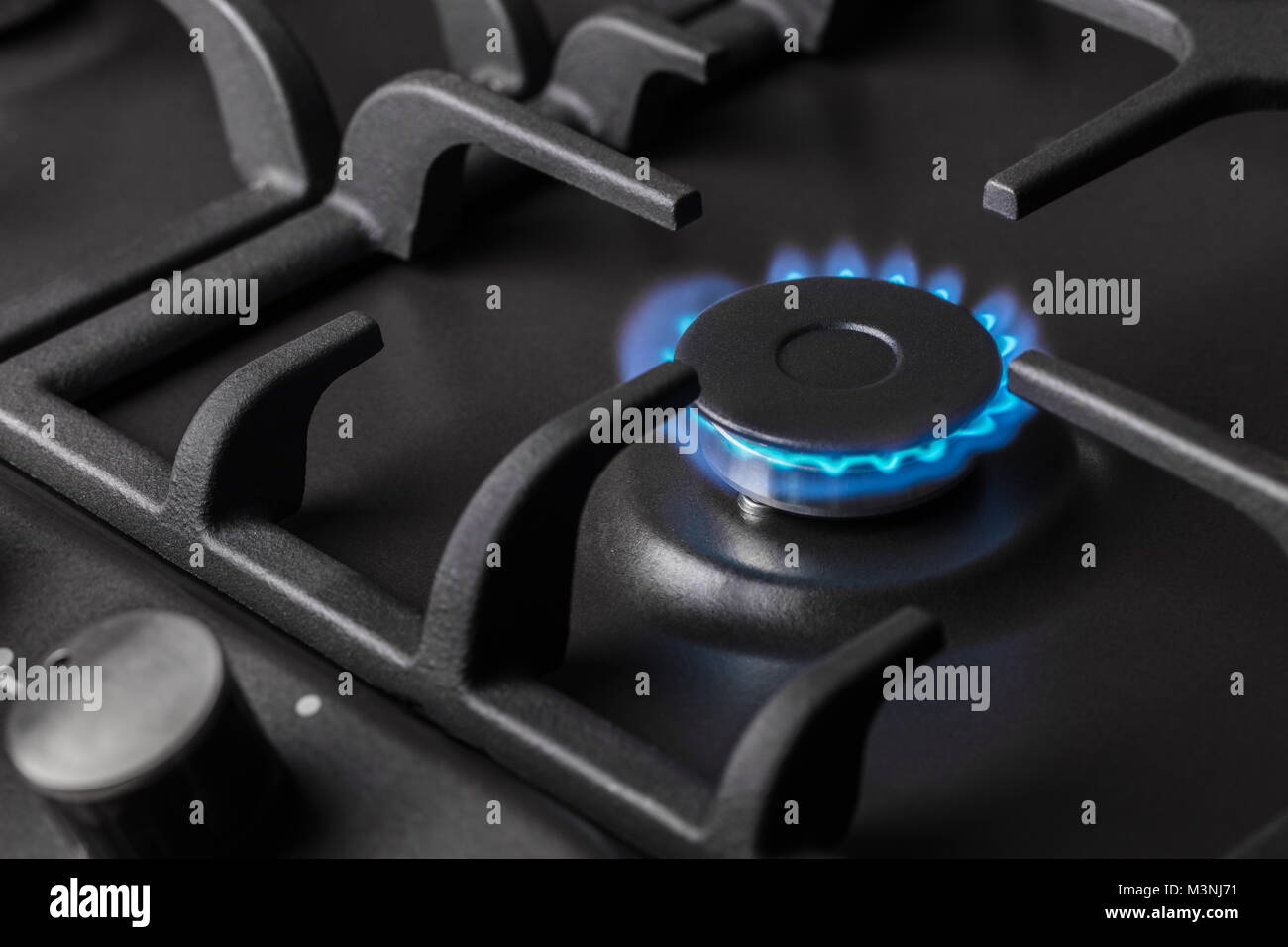 black kitchen gas stove burning burner close-up Stock Photo - Alamy