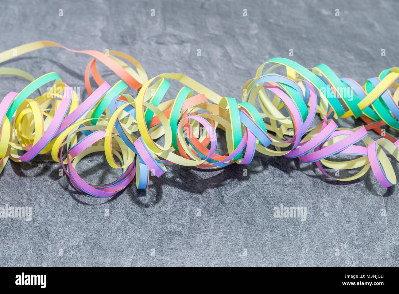 Paper streamer as carnival decoration on a slate Stock Photo - Alamy