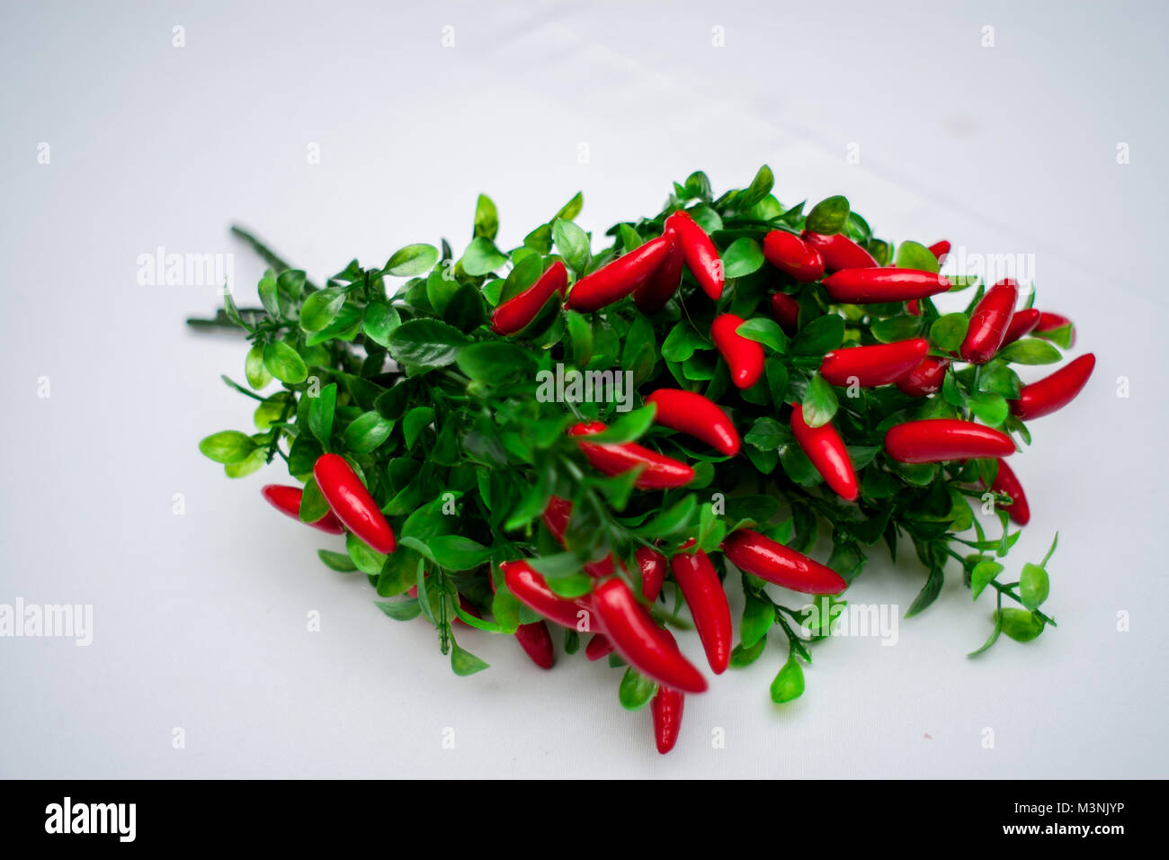 Sweet red pepper kapi, three peppers on white wooden table Stock Photo ...