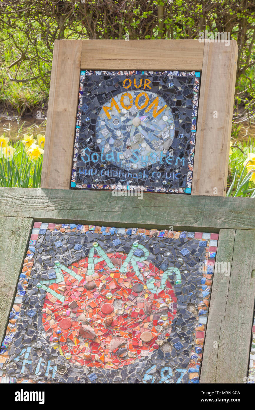 A woman views the Mosaic art work of the Solar System designed by ...