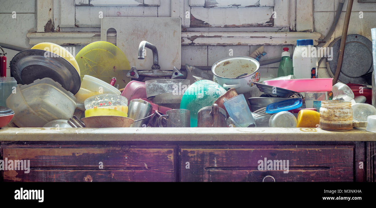 Pile of dirty utensils in a kitchen washbasin Stock Photo - Alamy