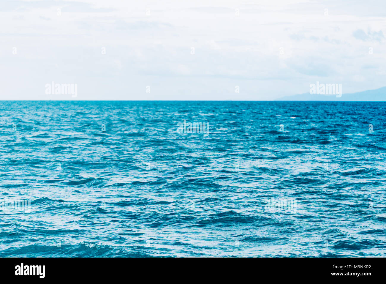 Bright Blue ocean with smooth wave background Stock Photo - Alamy