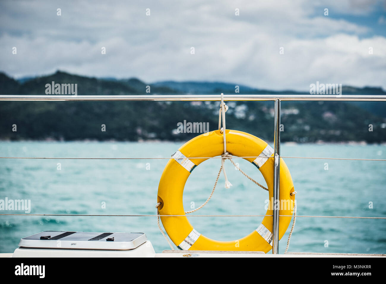 Close-up Yellow life ring hanging on boat with ocean background Stock ...