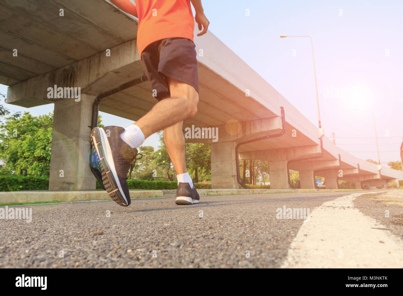 Running on the road with sunlight / The man runner Stock Photo - Alamy