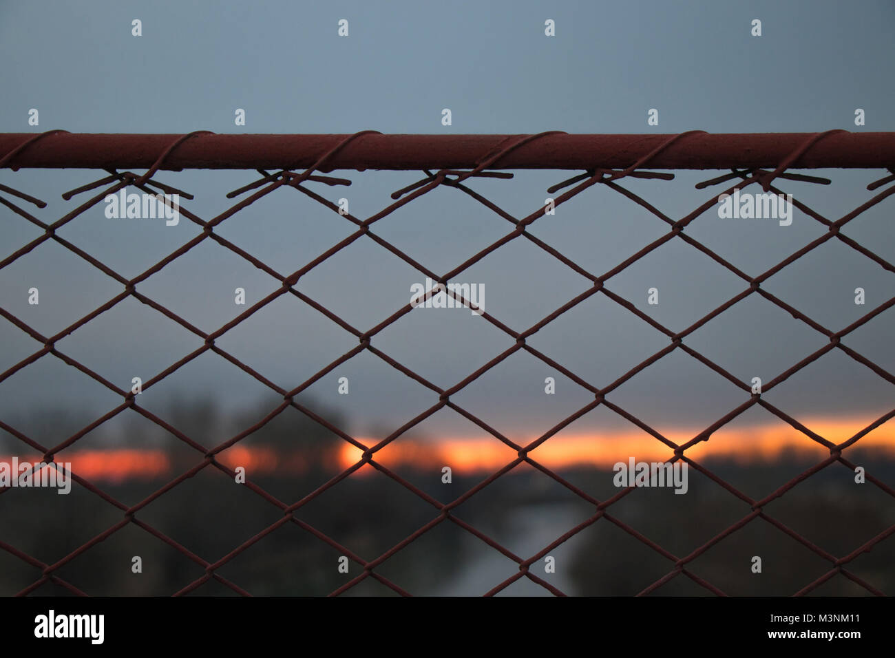 Wire fence at the sunset background Stock Photo - Alamy