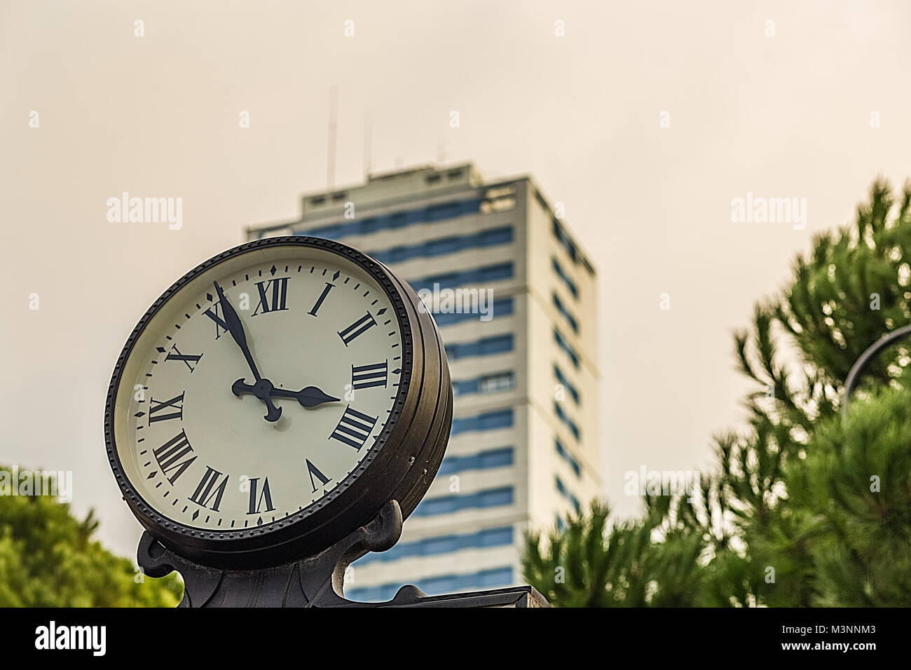 Retro Clock in Town Street with skyscraper on background Stock Photo ...