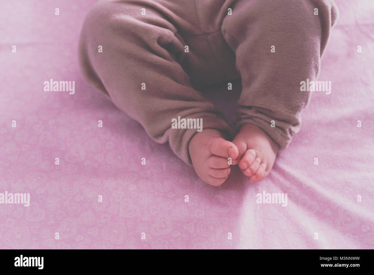Baby feet in the bed, top view Stock Photo - Alamy