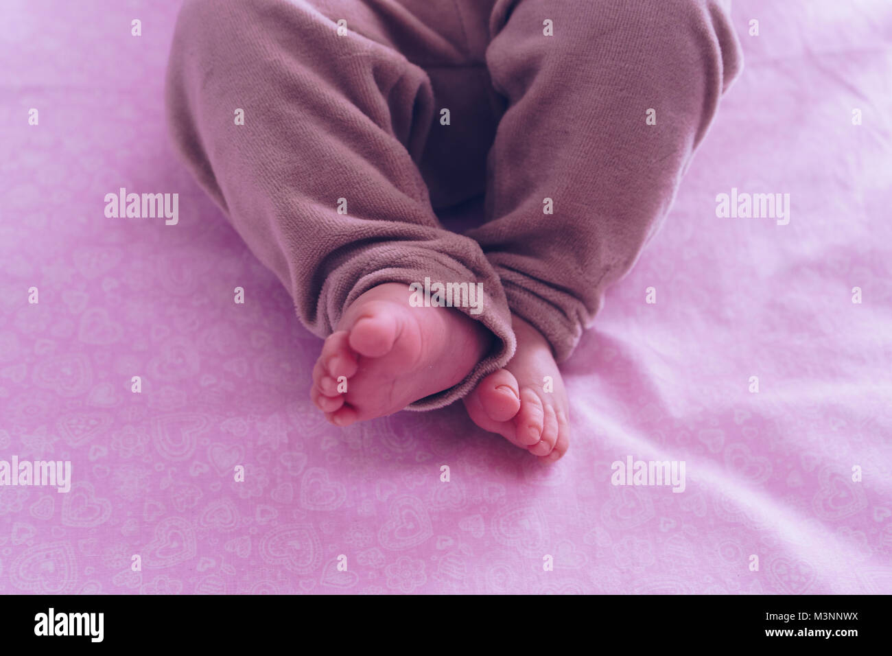 Baby feet in the bed, top view Stock Photo - Alamy