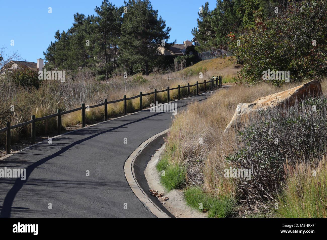 The trail system in San Marcos,CA consists of a paved path with railing ...