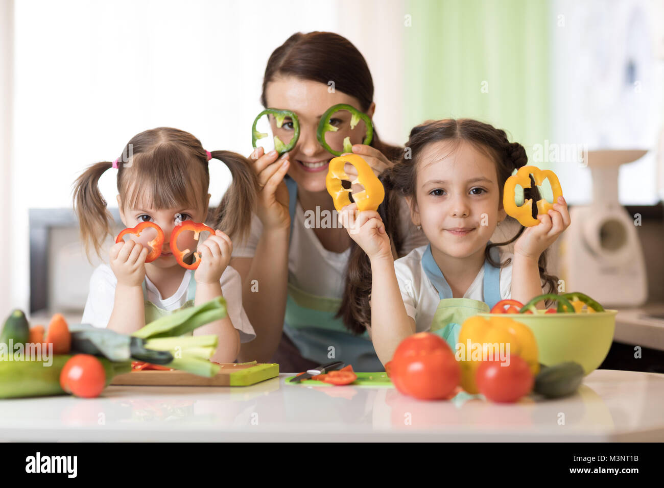 mother and kids daughters having fun in the kitchen Stock Photo - Alamy