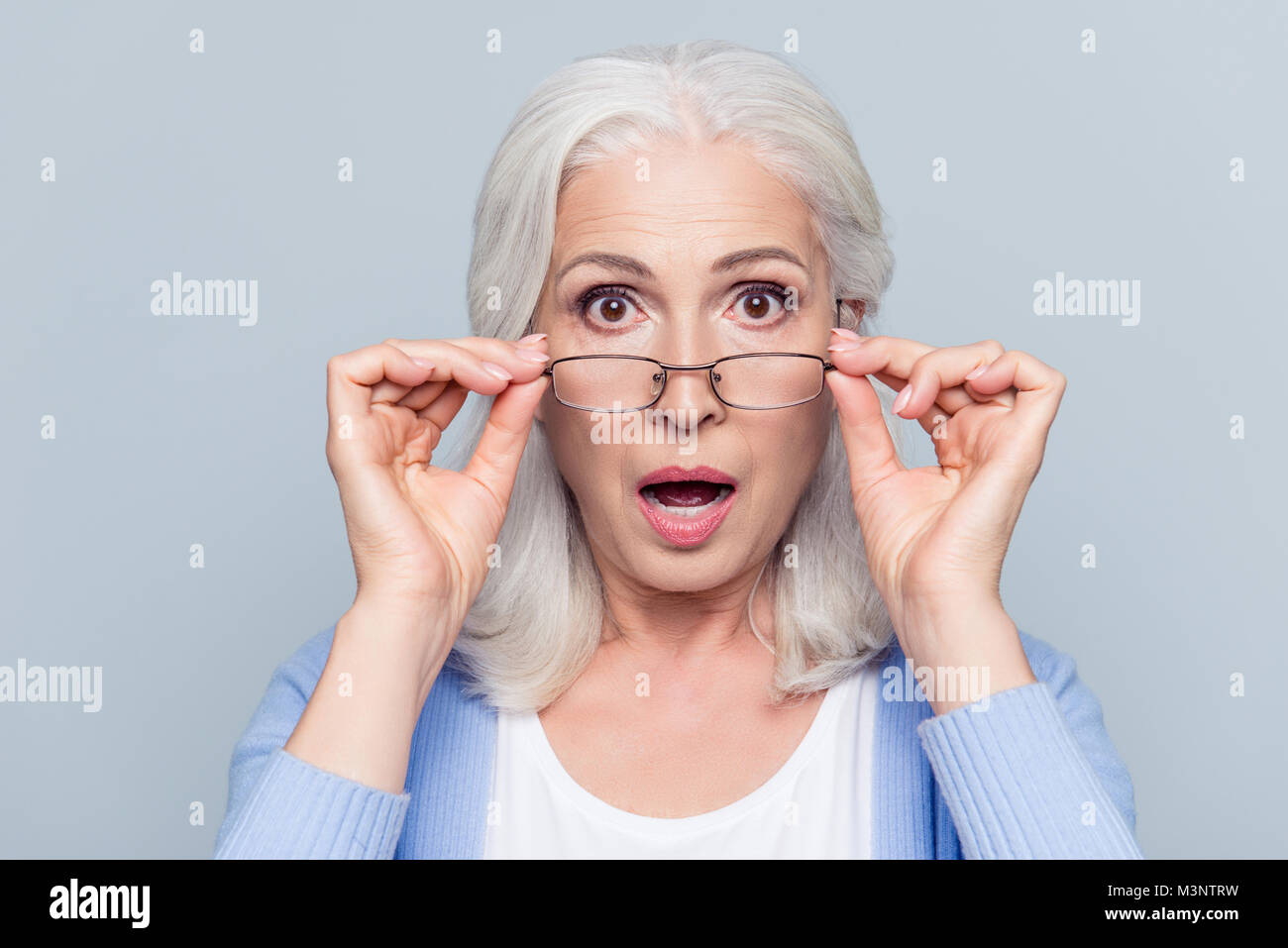 Woman peering over glasses hi-res stock photography and images - Alamy