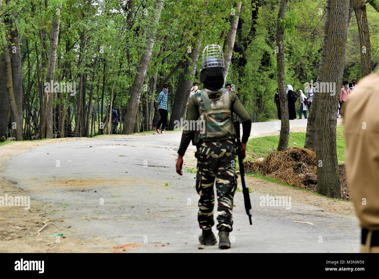 policeman running Kashmiri students protesting, Kashmir, India, Asia ...