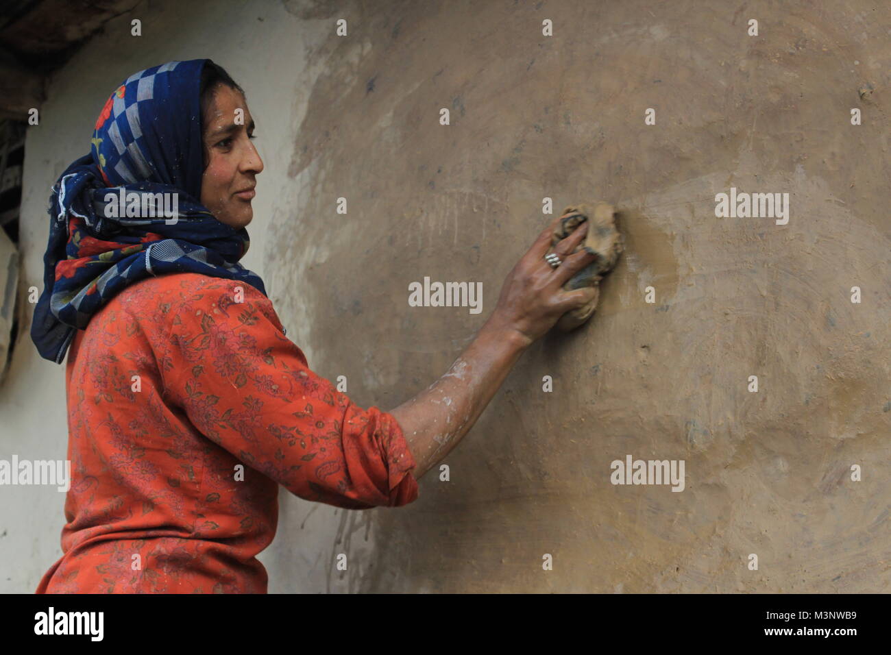 Applying cow dung hi-res stock photography and images - Alamy