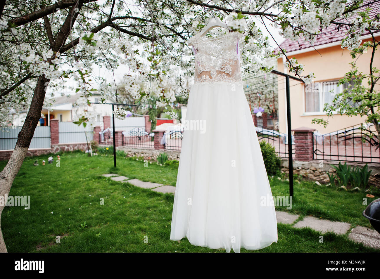 Wedding dress hanging on tree hi-res stock photography and images - Alamy