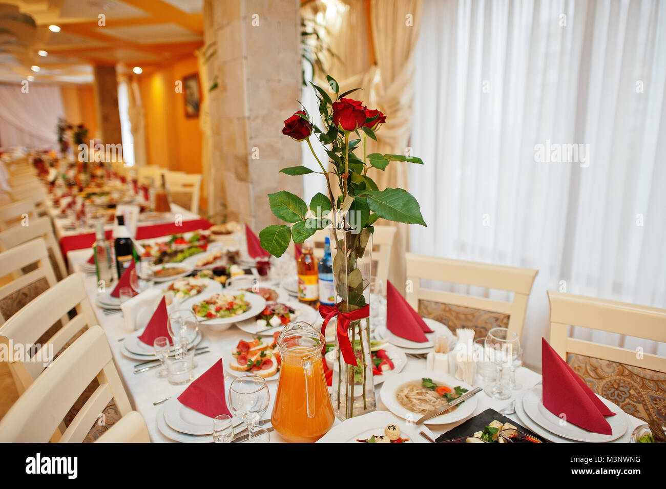Wedding table decorated with red roses in the restaurant Stock Photo ...