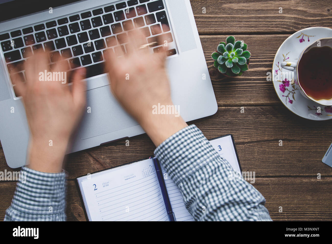 Man working on laptop placed on wooden desk Stock Photo - Alamy