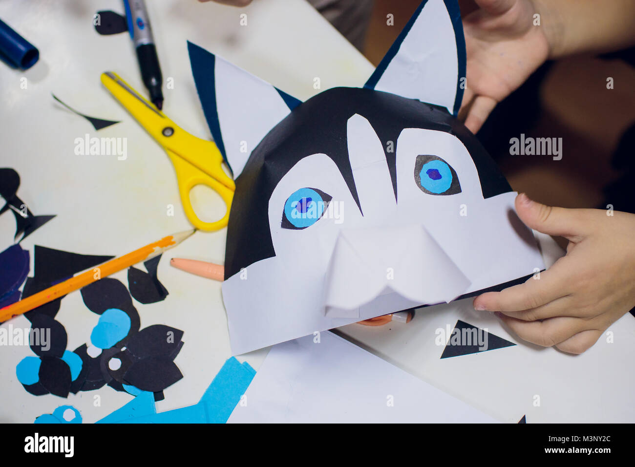 children make masks of husky dogs craft Stock Photo - Alamy