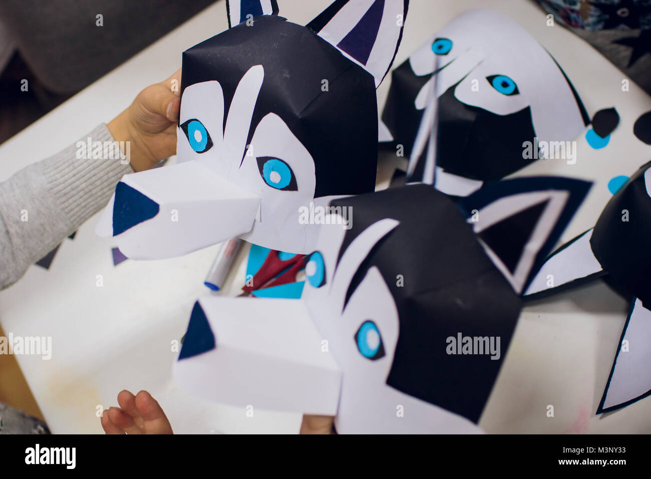 children make masks of husky dogs craft Stock Photo - Alamy