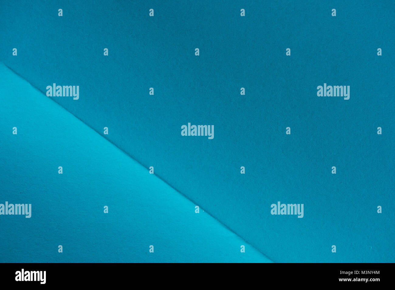 close-up shot of folded blue paper for background Stock Photo - Alamy