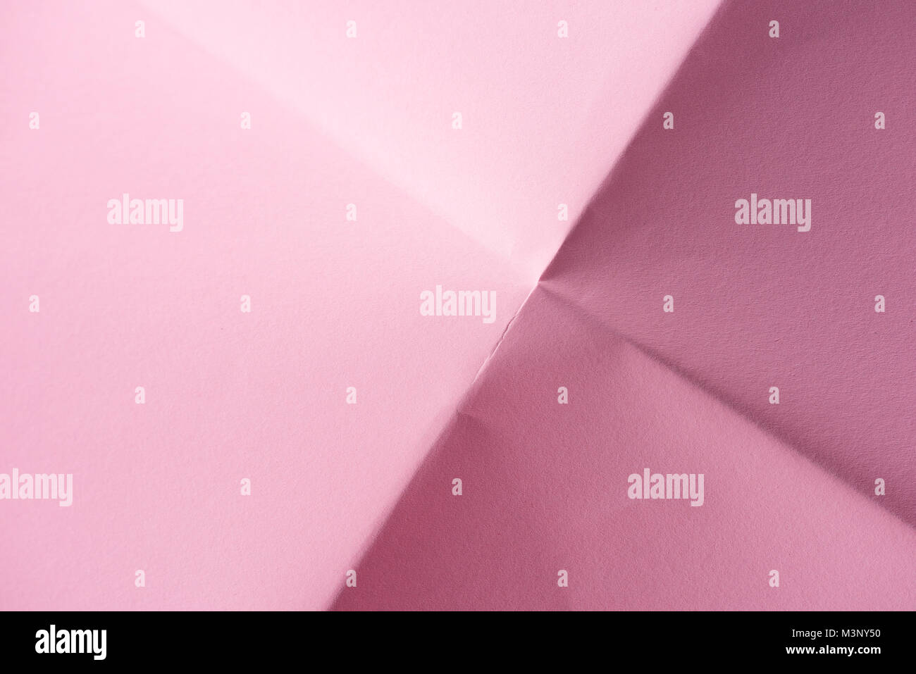 close-up shot of folded pink paper for background Stock Photo - Alamy