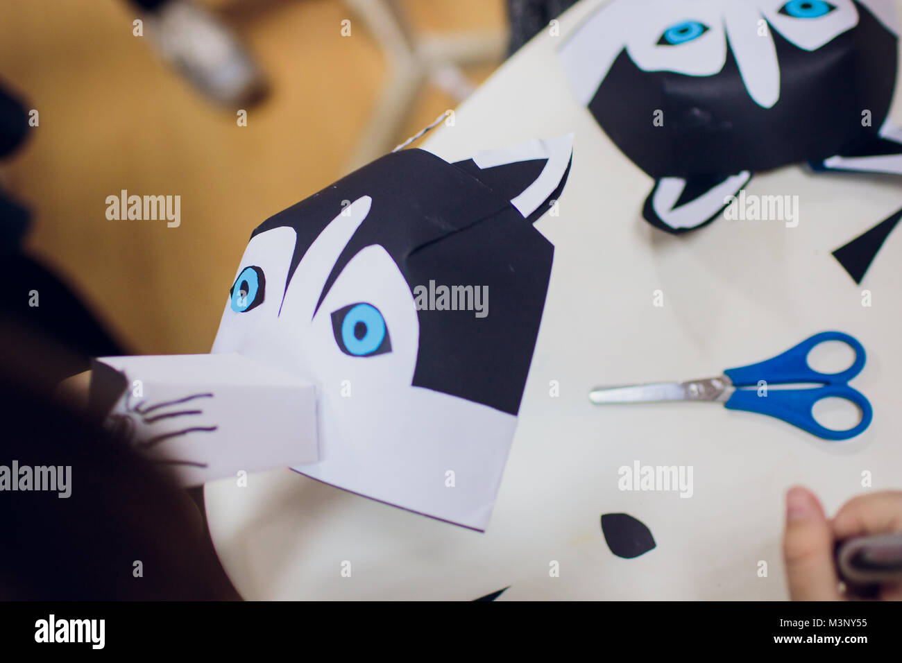 children make masks of husky dogs craft Stock Photo - Alamy
